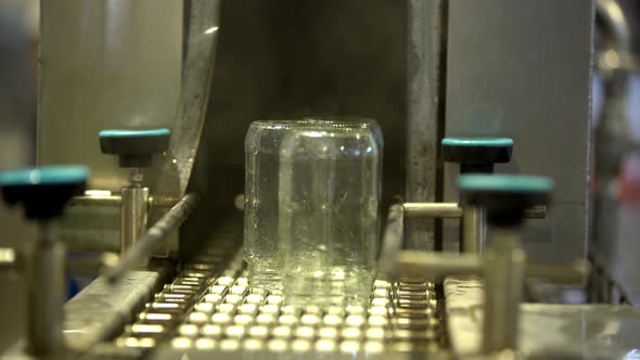 Conveyor of sterile cans. Empty cans move to sterile conveyor in ...