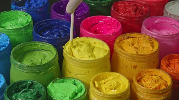 Use A Spoon To Stir The Mastic In The Bucket., Stock Footage | VideoHive