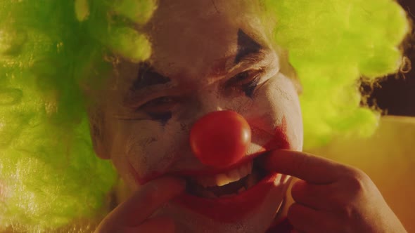 A Clown with Crumbling Paint on His Face Creepy Smiling Stretches His ...