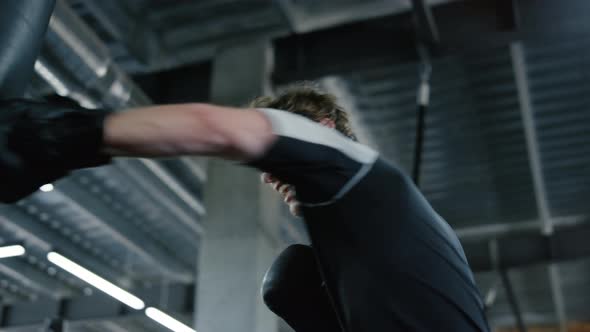 Emotional Fighter Hitting Boxing Bag in Fitness Center. Kickboxer ...
