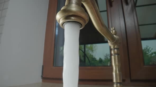 Strong Stream of Water Flowing From a Faucet in the Kitchen or Bathroom ...