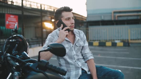 Young Man Motorcyclist Talking on the Phone While Sitting on Custom ...