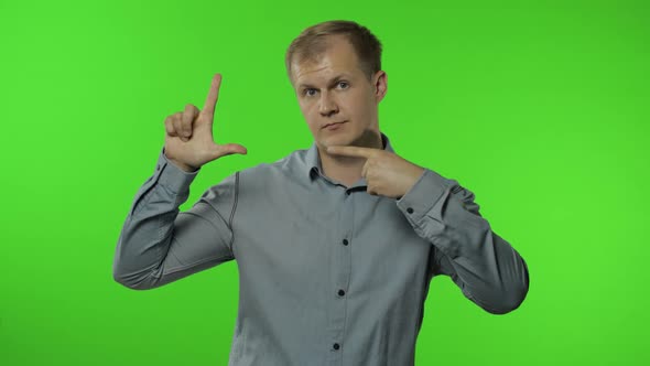 Guy Showing Loser Gesture, Pointing Finger To Camera, Sarcastic Smile ...