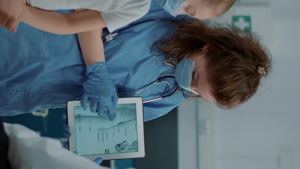 Vertical Video Nurse Using Tablet with Human Skeleton Picture to Give ...