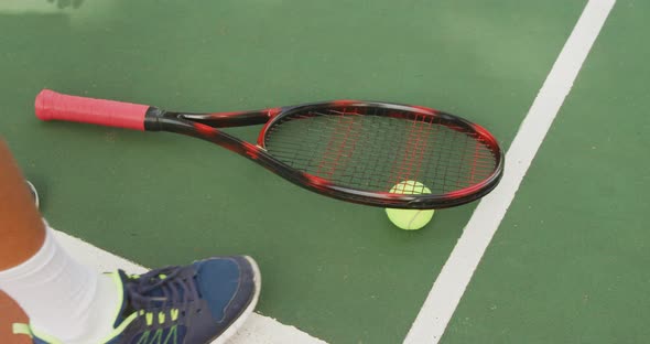 Someone picking up tennis racket and ball, Stock Footage | VideoHive