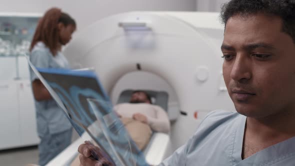 Doctor Reading X-Ray of Patient in CT Scan Room, Stock Footage | VideoHive