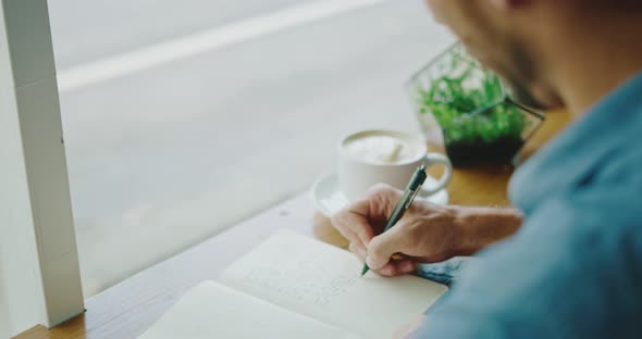 Man Writing in Coffee Shop, Stock Footage | VideoHive