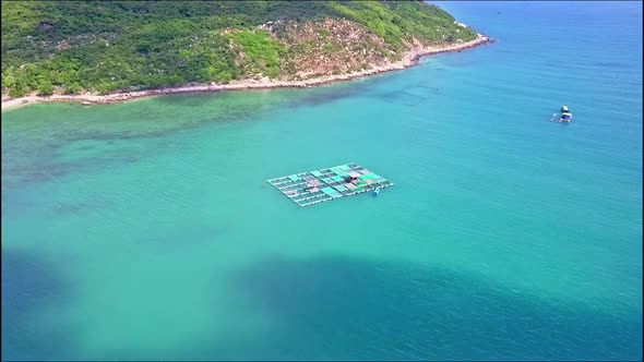 Flycam Moves To Floating Lobster Farm Among Calm Blue Ocean, Stock Footage