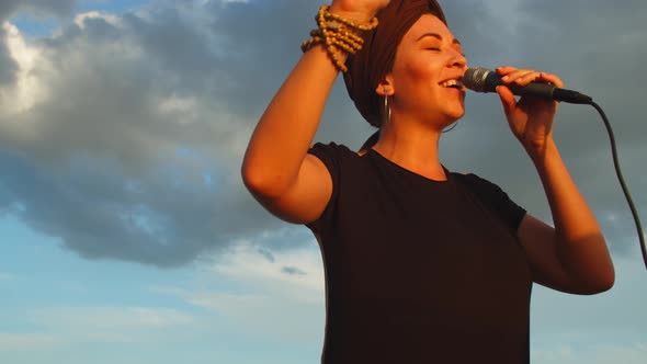 Singer Is Performing Outdoors, Beautiful Sky During Sunset, Ethnic ...