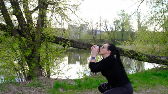 beautiful woman working out in spring park. Summer concept of squatting ...