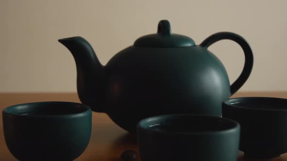 minimal background of a green japanese tea set with steam coming out of ...
