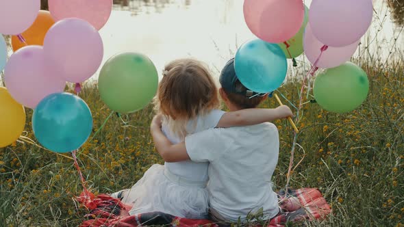 Children with Balloons Hugging Sitting on a Plaid, Stock Footage ...