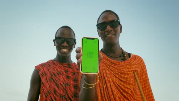 Extremely Happy Masai Tribe Men Showing Green Screen on Smartphone and ...