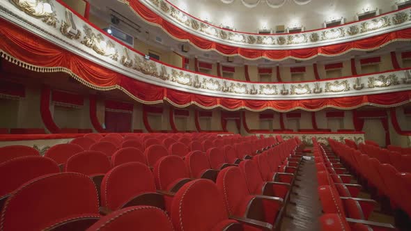 Rows of red chairs in theater hall. Beautiful empty opera house without ...