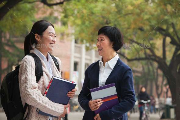 University Student and Professor on Campus Stock Photo by XiXinXing