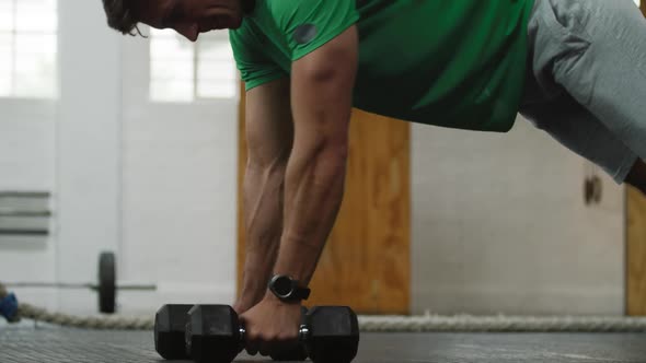 Side view athletic Caucasian man lifting alternate weights, Stock Footage