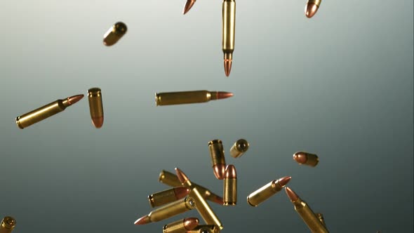 Bullets falling bouncing in ultra slow motion 1500fps on a reflective ...