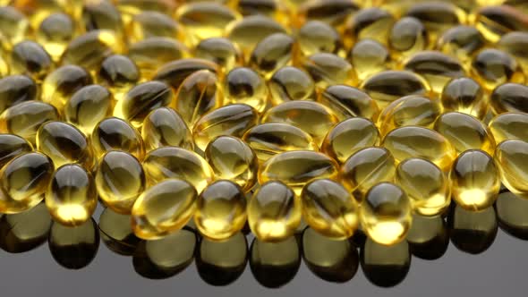 Omega 3 gold oil capsules close up, rotation. Supplement organic ...