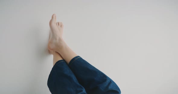 Female feet up against wall close up, Stock Footage | VideoHive