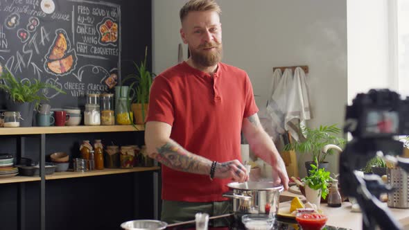 Food Blogger Cooking Food and Talking on Camera in Kitchen, Stock Footage