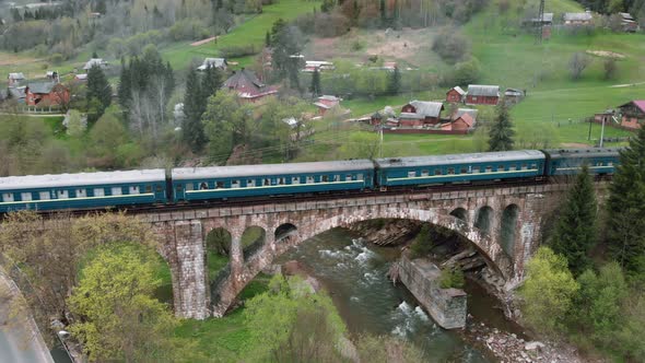 Train passing over bridge. Passenger train crossing old viaduct bridge ...