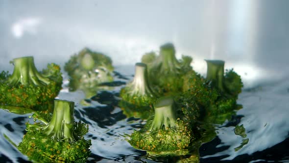 Pieces of Green Broccoli Float on The Waves of Clear Transparent Water ...
