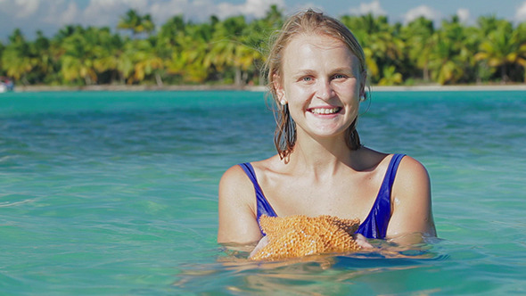 Smiling Woman In Sea Water With Starfish, Stock Footage | VideoHive