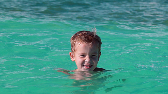 Little Boy Bathing In Clear Blue Sea, Stock Footage | VideoHive