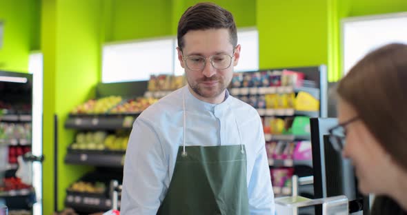 View of Smiling Cashier Scanning Goods at Checkout, Stock Footage ...