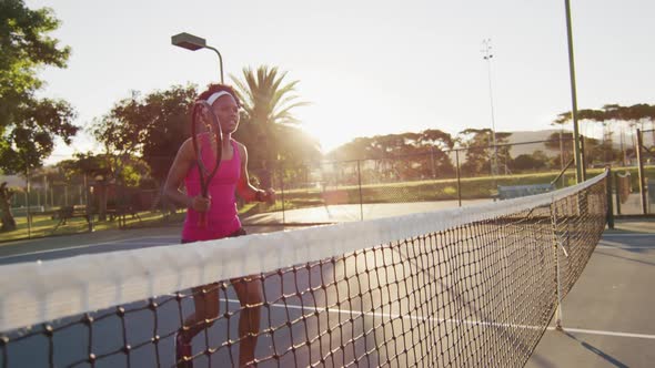 Video of happy african american female tennis player holding racket and ...