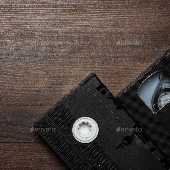 Old Retro Video Tape Over Wooden Background Stock Photo by garloon