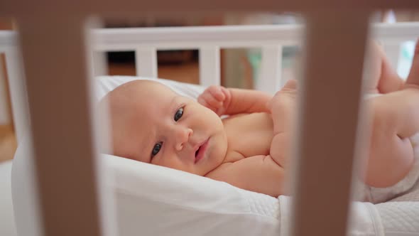 a Newborn Baby Lies in a White Crib in Cocoonababy for Newborns View ...