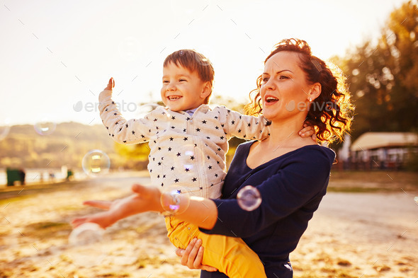 Mom and son having fun by the lake Stock Photo by arthurhidden | PhotoDune