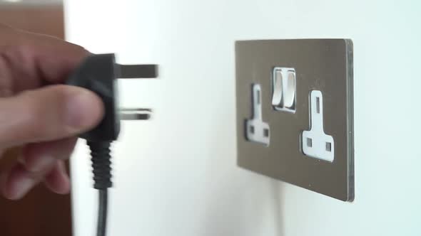 Man Putting Plug Into Electrical Socket, Stock Footage | VideoHive