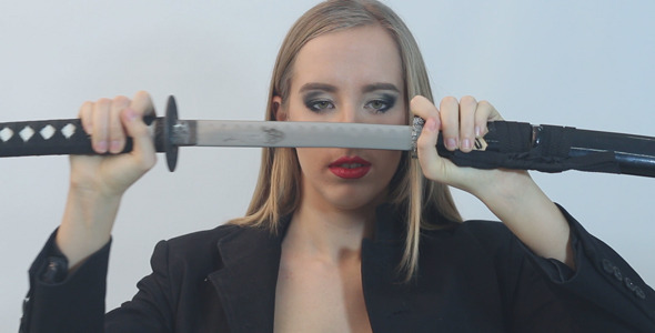 Girl Pulls out a Samurai Sword From its Sheath, Stock Footage | VideoHive