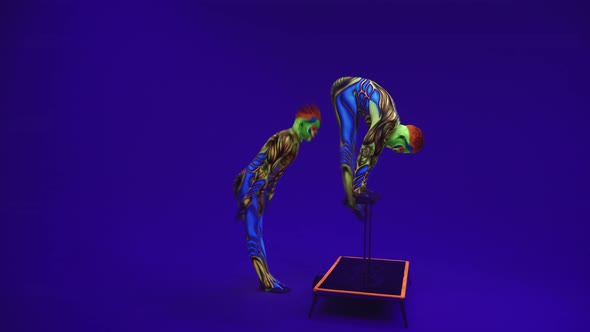 Acrobats In Luminous Ultraviolet Suits Do Racks And Transverse Splits ...