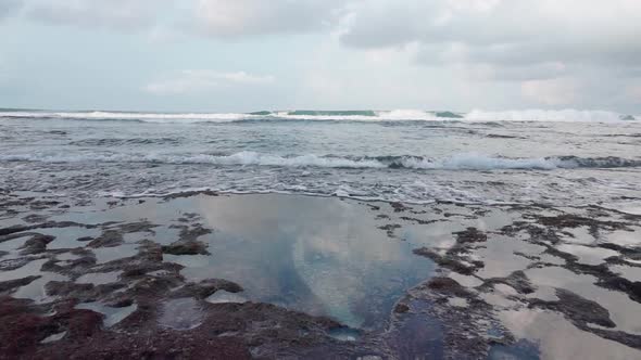water stream from sea wave on the coral. beach wave in the coral beach ...