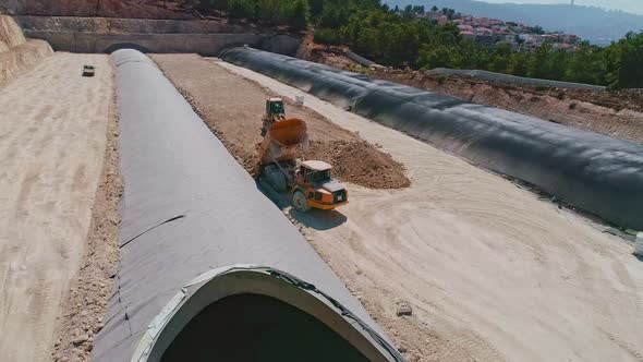 Aerial footage of large highway construction project with tunnels and ...