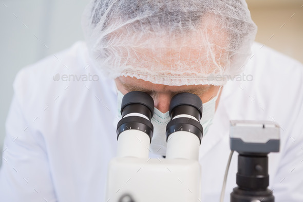 Scientist examining sample with microscope in the laboratory Stock ...
