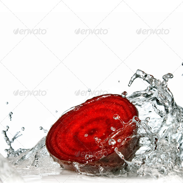 red beet with water splash isolated on white Stock Photo by Artjazz