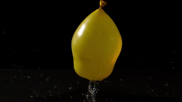 Yellow Water Balloon Falling On Black Background, Stock Footage | VideoHive