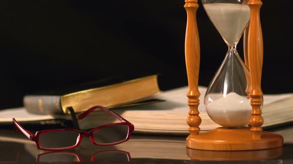 Reading Glasses Falling Beside Hourglass And Bible, Stock Footage ...