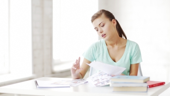 Happy Female Student Throwing Papers Up At Home, Stock Footage | VideoHive