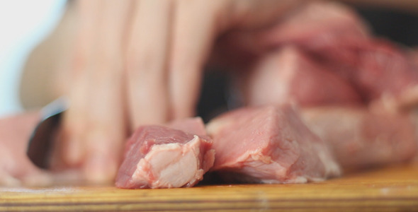 Man Cut the Meat into Small Pieces with a Knife, Stock Footage | VideoHive