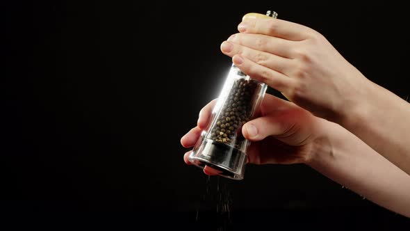 Adding Pepper to Dish on Black Background Using Seasoning and Flavors ...
