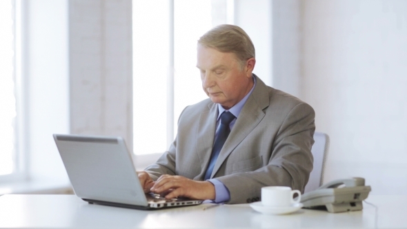 Senior Man With Laptop Taking Phone Call, Stock Footage | VideoHive