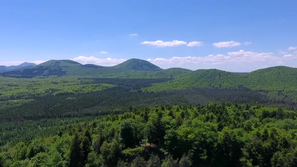 Drone Pull Back and Reveal Shot of Volvic Volcano and Forest in France ...