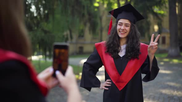 Laughing Beautiful Woman in Graduation Toga Gesturing Posing Outdoors ...