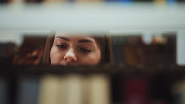 Student in Search of Book on Library Shelves, Stock Footage | VideoHive