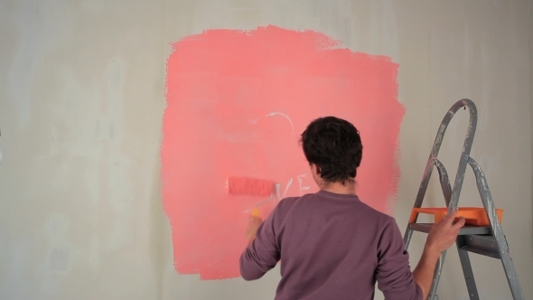 Man Paints The Writing On The Wall., Stock Footage | VideoHive